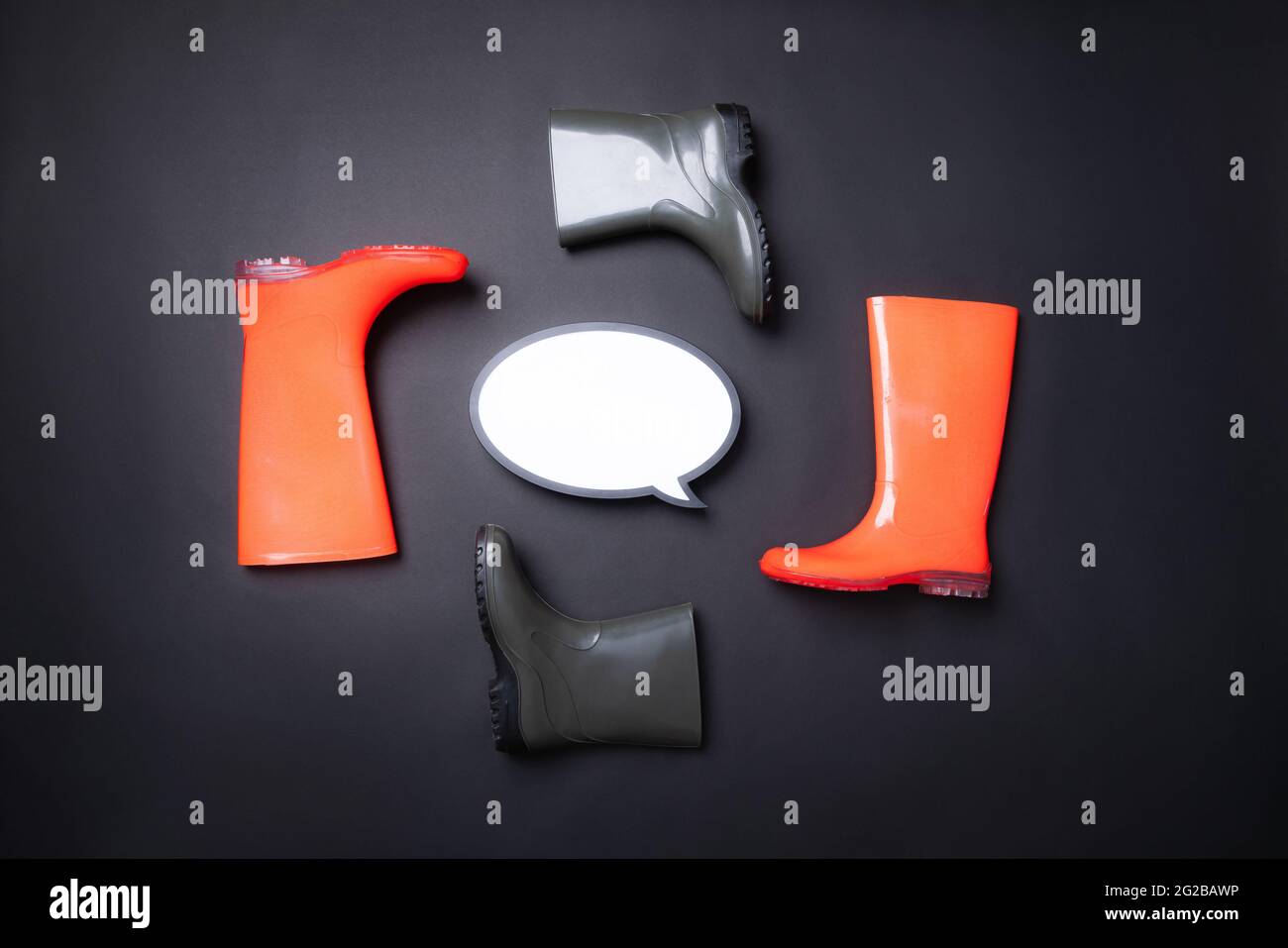 Rubber shoes and speech bubble on black background. Rain season and ...