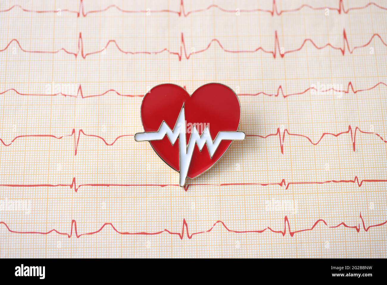 Electrocardiogram with emblem of the heart lie on table at cardiologist ...