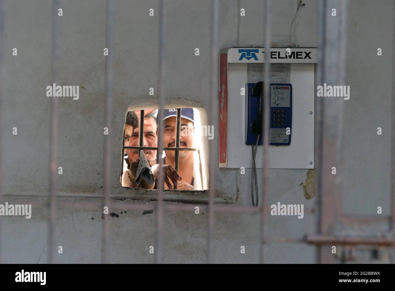 CABO, MEXICO - Feb 10, 2005: Inmates peaking out of a jail cell in ...
