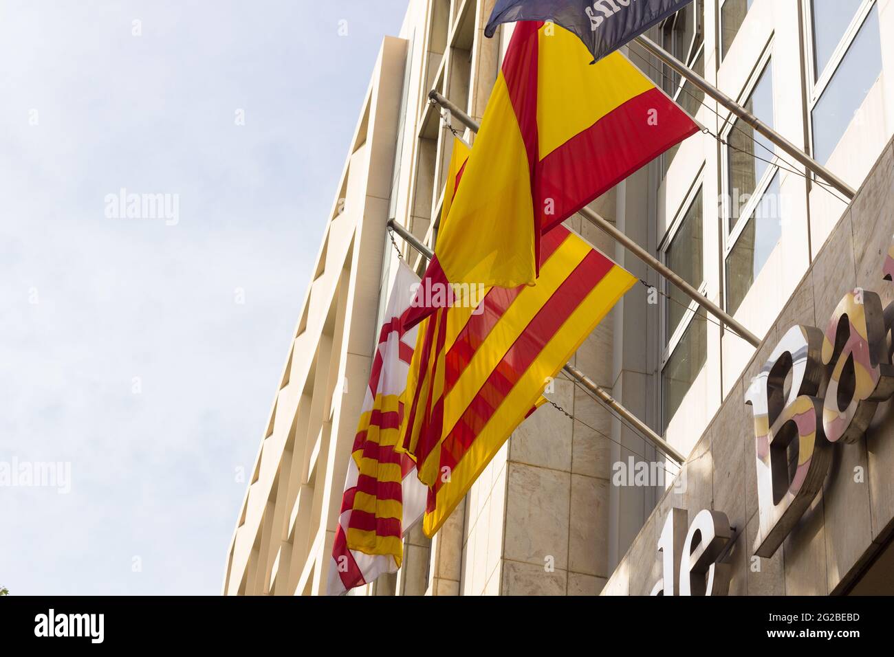 Flags flying on the outside of a building, Catalan, Spanish and ...
