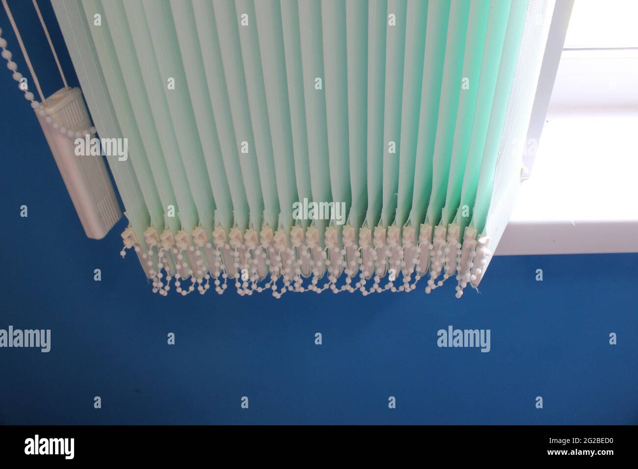 Closed vertical blinds against the background of the window Stock Photo ...