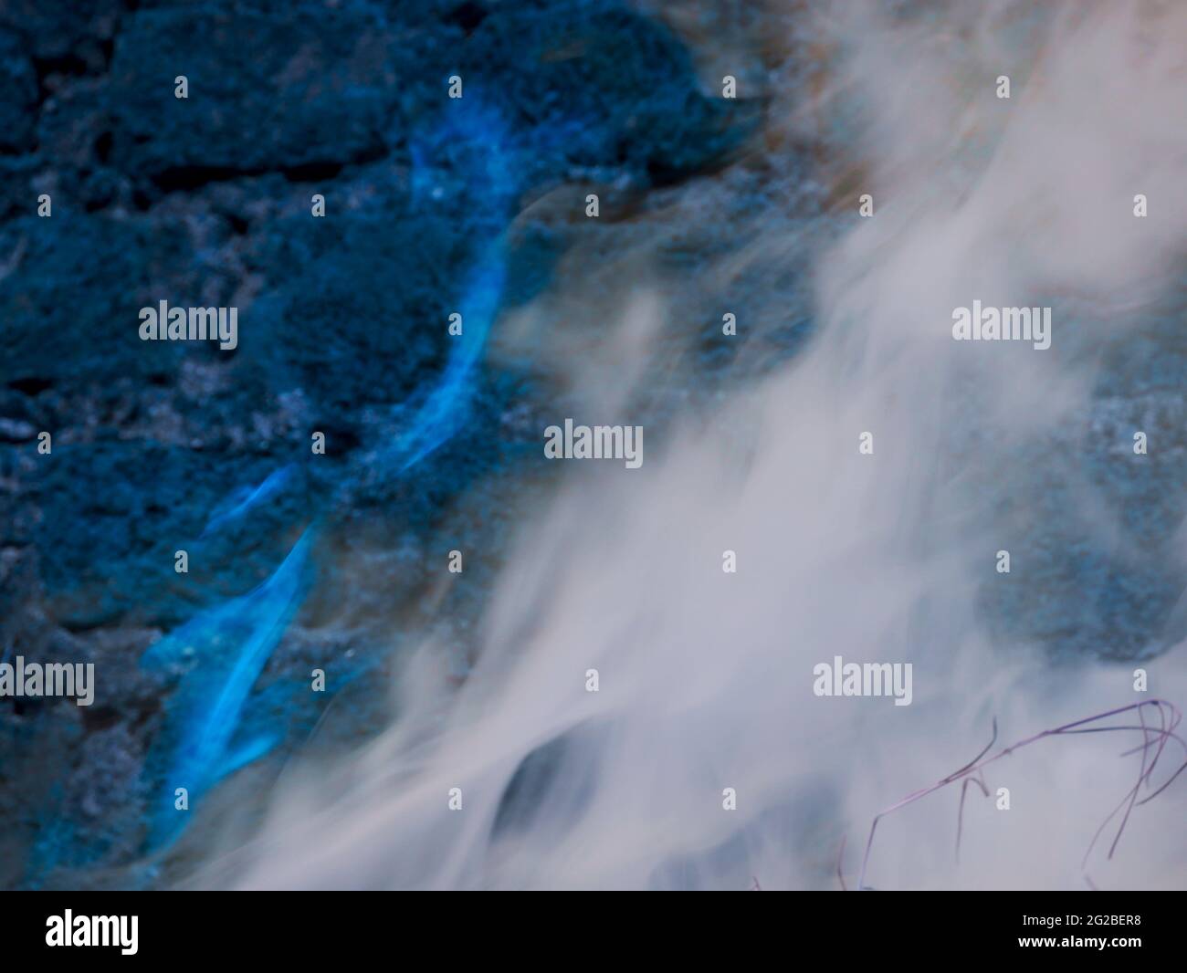 Burning blue fire with heavy fog on blur brick wall background Stock ...