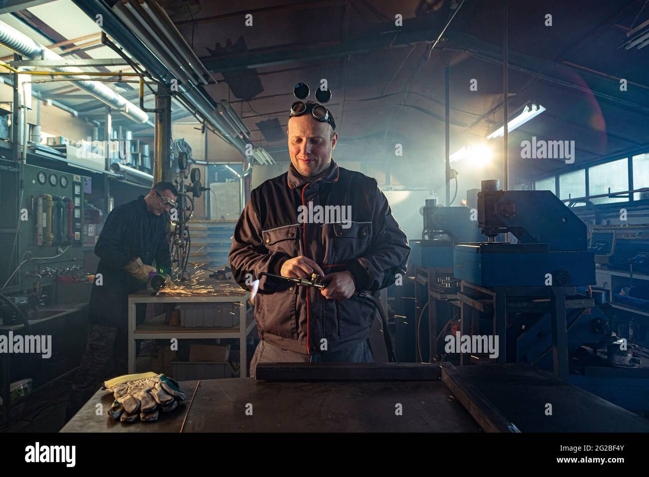 Handyman preparing his autogenous welding tool for work while his ...