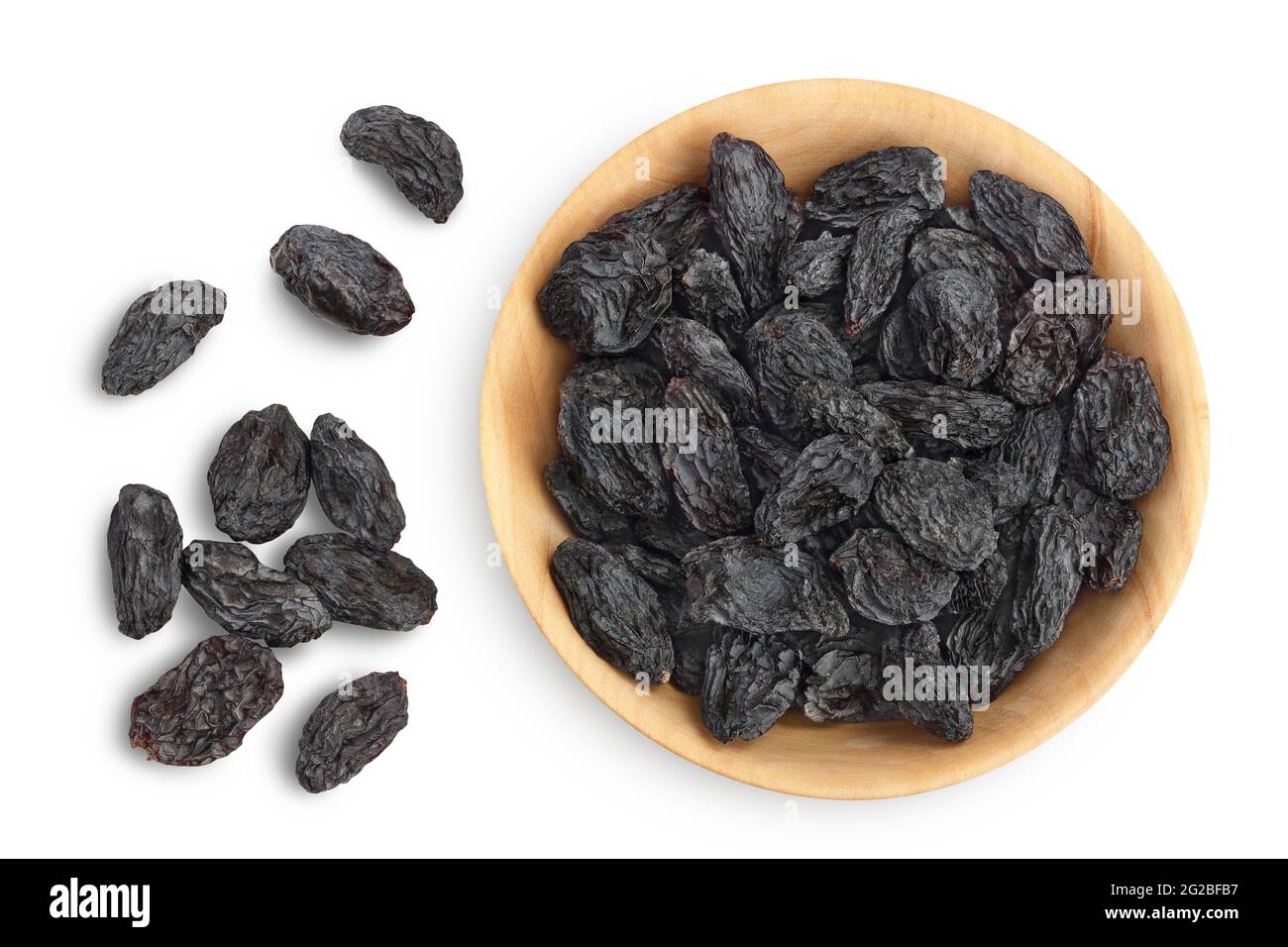 Black raisin iin wooden bowl solated on white background with clipping ...