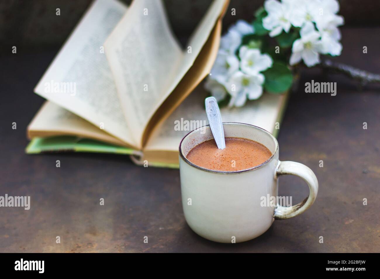 A cozy Easter, spring still-life scene. A cup of coffee, a book, a ...