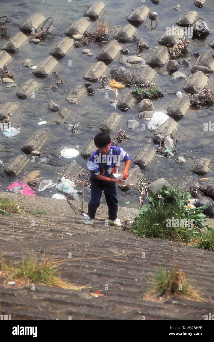 TOKYO, JAPAN - Jun 04, 2021: Japanese boy removes trash from garbage ...