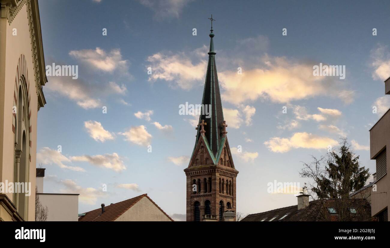 Church tower over the roofs of the city Stock Photo - Alamy