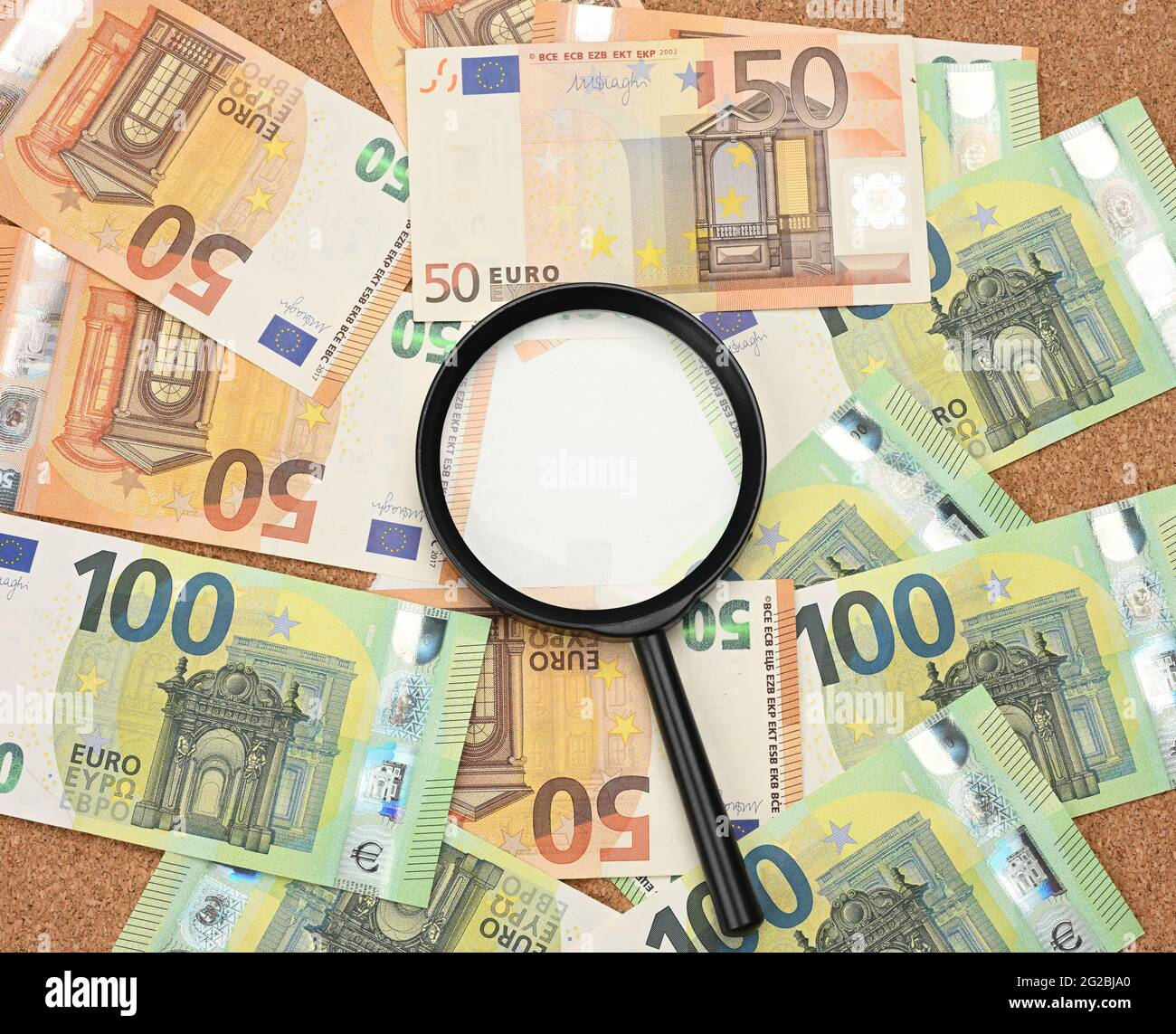 pile of euro paper bills and black plastic magnifier, top view Stock ...