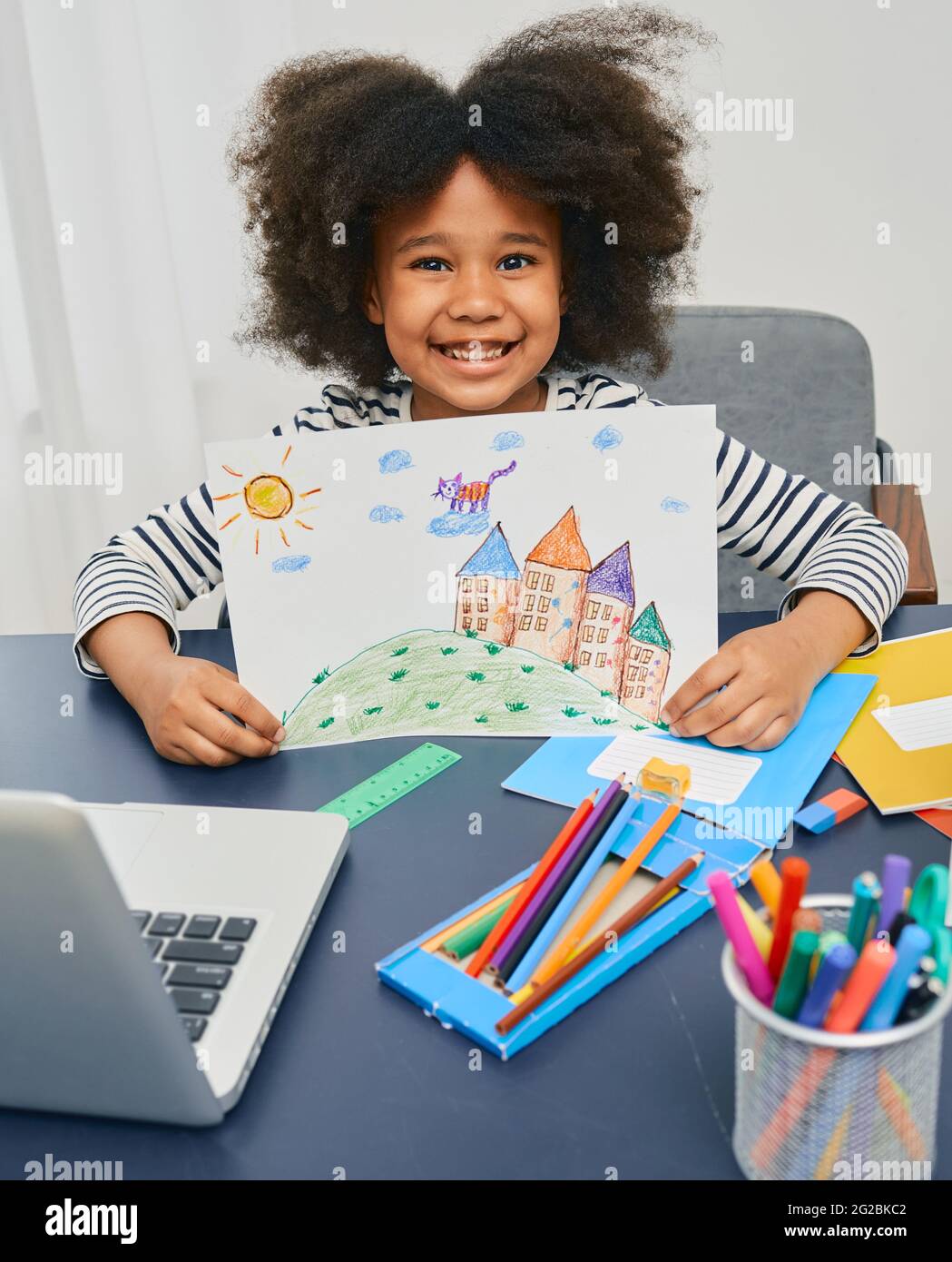 Creative little girl drew a picture with pencils and is very happy with ...