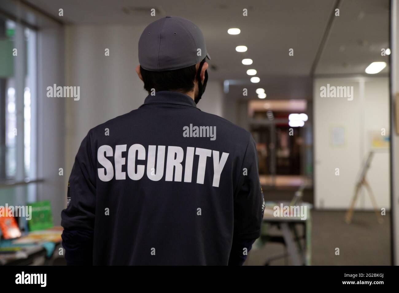 Closeup shot of a security guard in uniform patrolling in a commercial ...