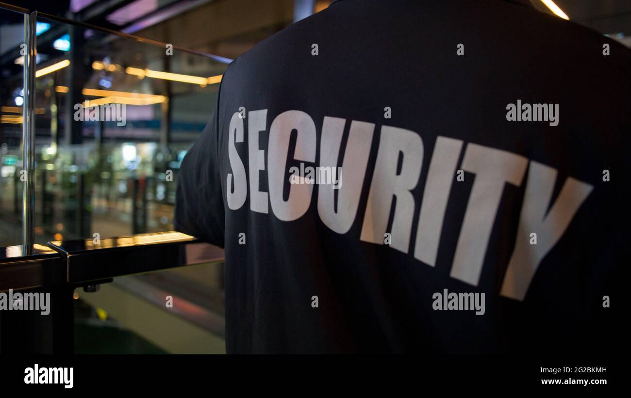 Closeup shot of a security guard walking through the street of the big ...