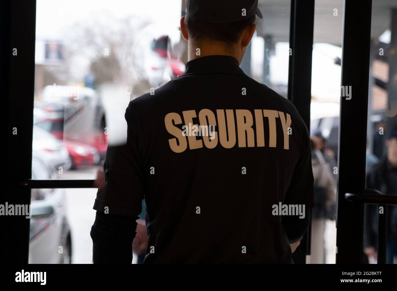 Closeup shot of a security guard in uniform patrolling in a commercial ...
