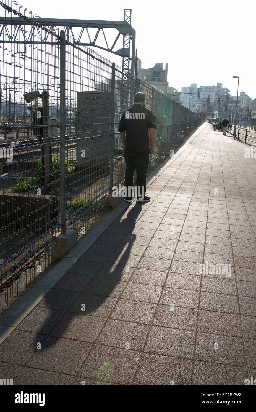 Closeup shot of a security guard in uniform patrolling at a station ...