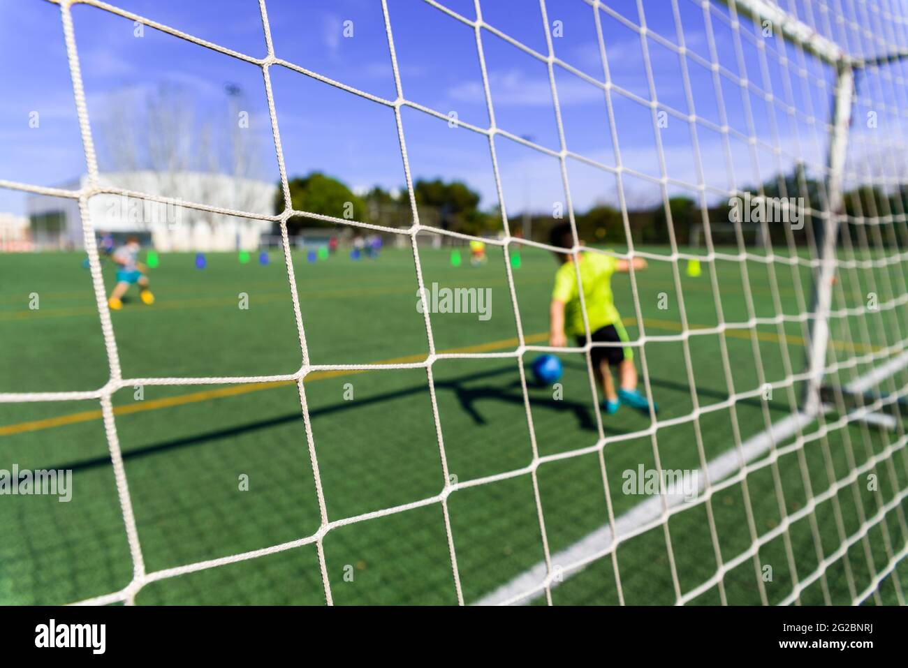 Soccer player in a goal tries to stop a ball, background with copy ...