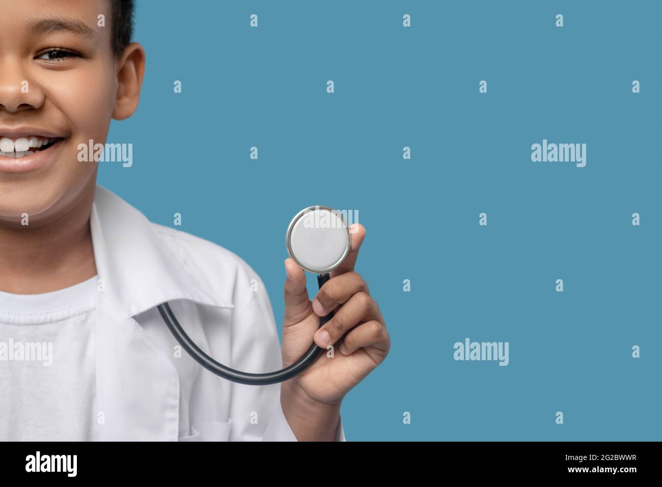 Close up half face of laughing boy with stethoscope Stock Photo - Alamy