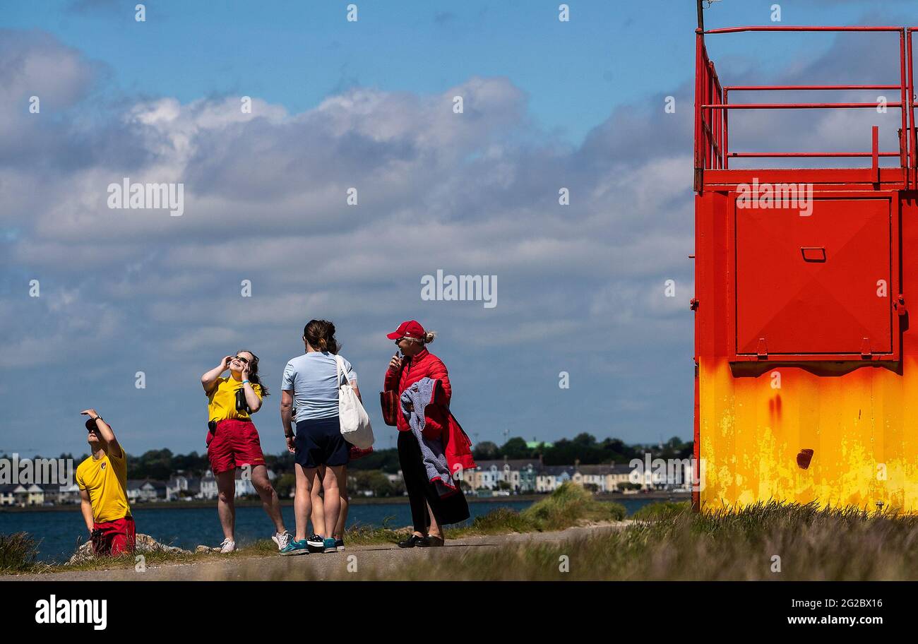 A lifeguard uses solar viewing glasses on Bull Wall in Dublin to look ...