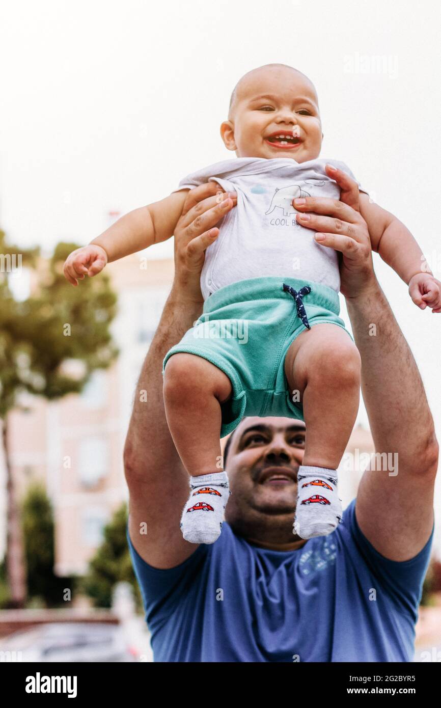 Father playing with his baby. Dad throws son to the air Stock Photo - Alamy