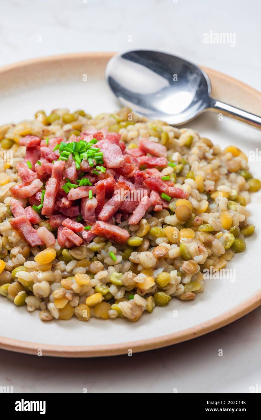 porridge of legumes with fried bacon and chive Stock Photo - Alamy