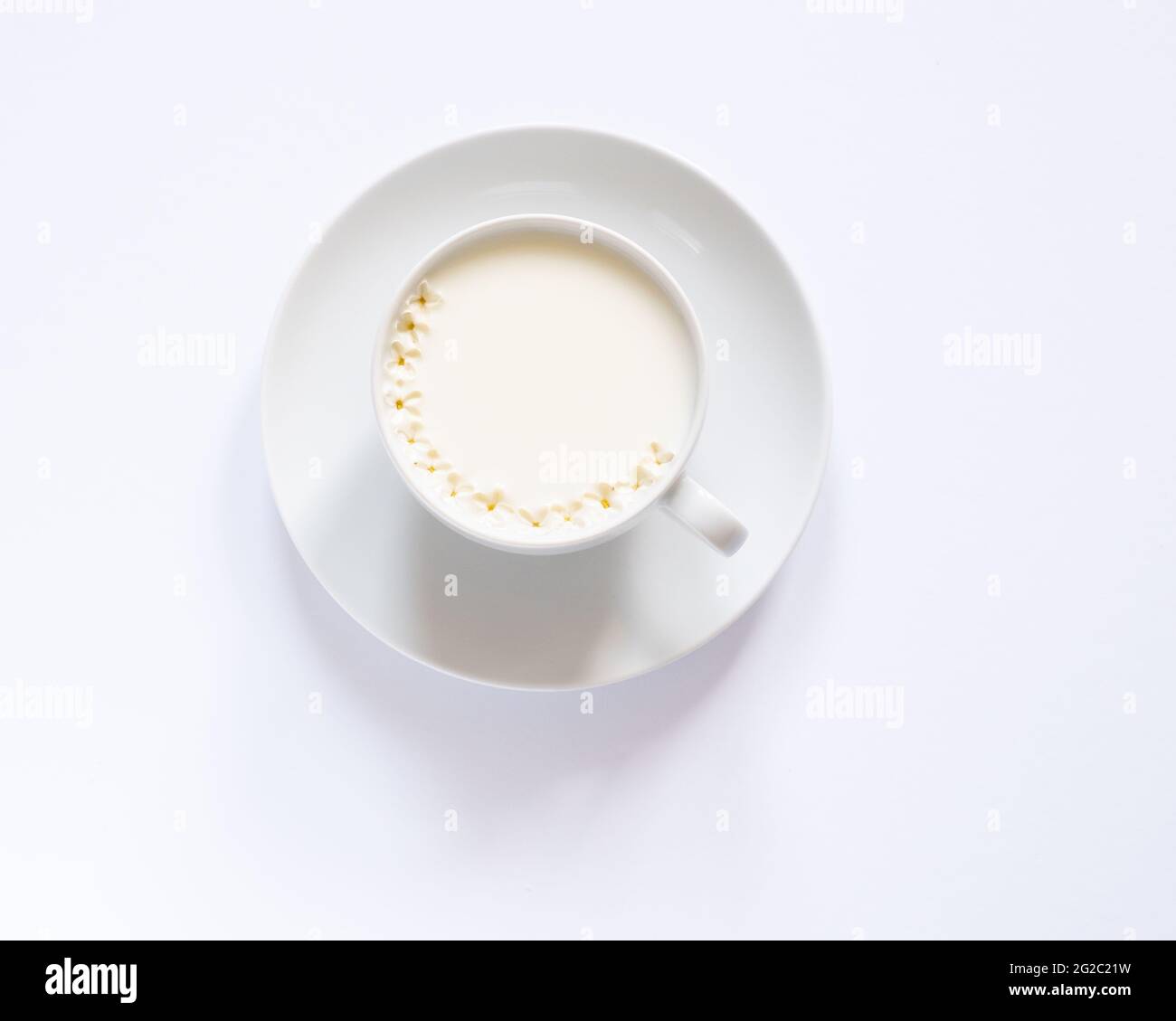 white cup with milk on a white background Stock Photo - Alamy