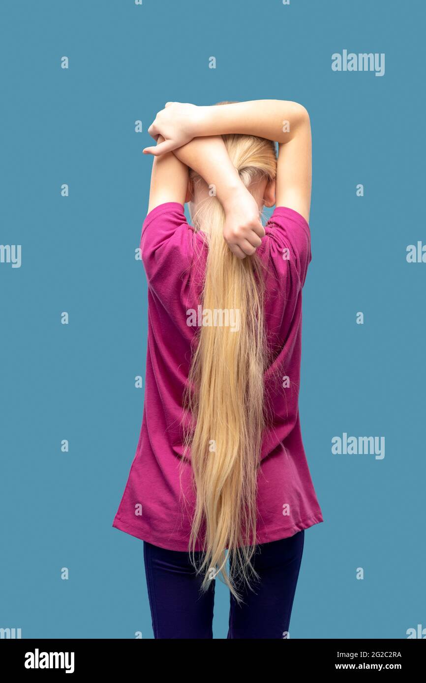 Back view of girl doing stretching Stock Photo - Alamy