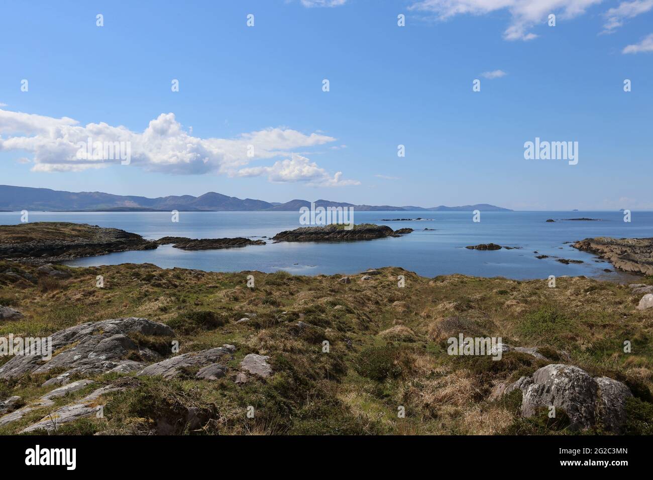 Beautiful view of a rocky lakeside against a blue and cloudy sky Stock ...