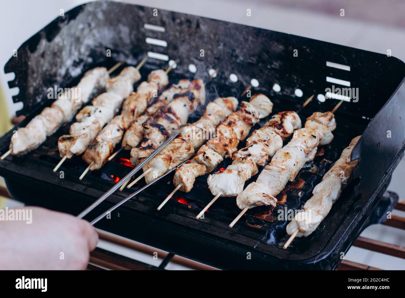 Man charcoal grilling chicken hi-res stock photography and images - Alamy