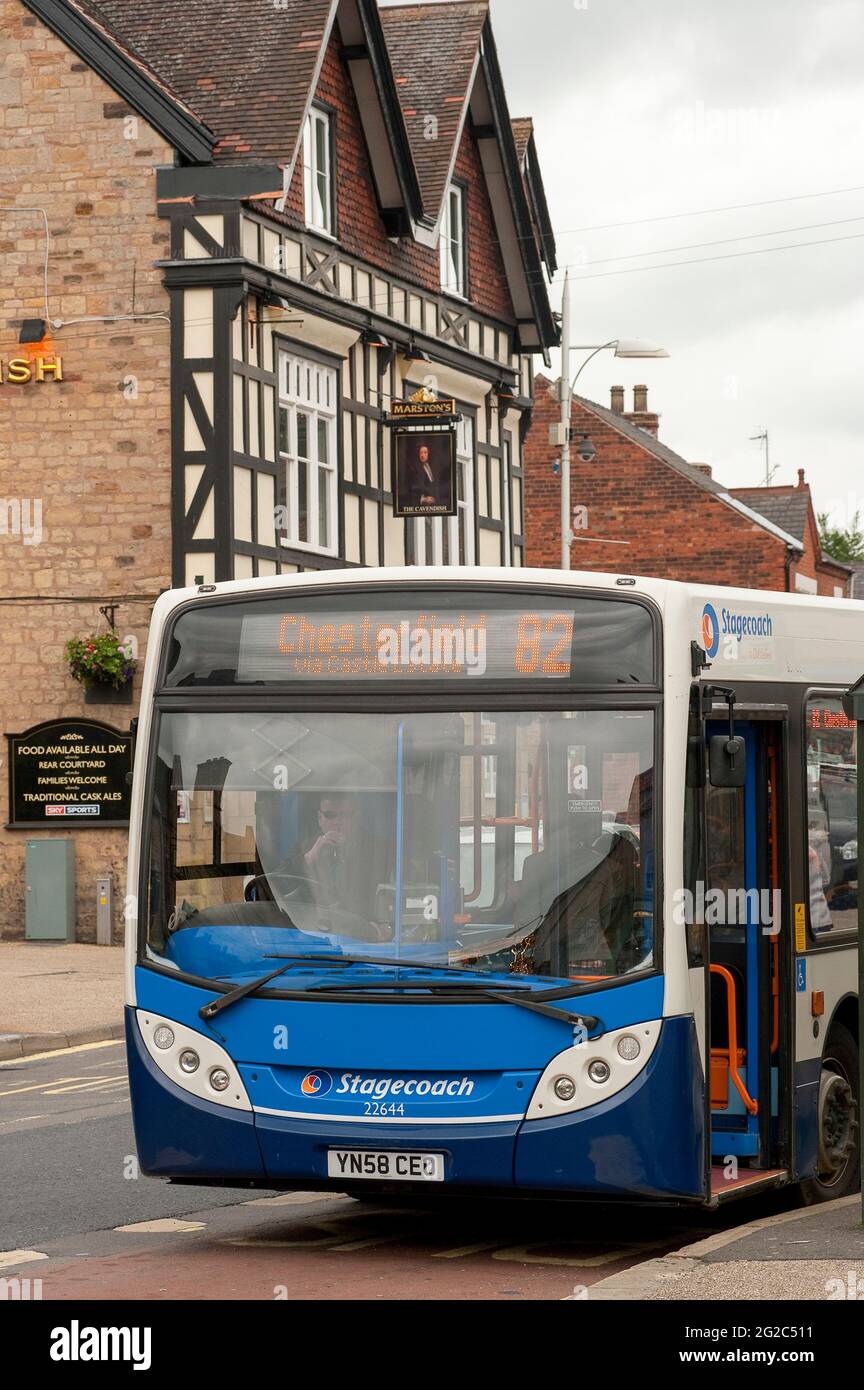 Bus at a bus stop in the market town of Bolsover with The Cavendish pub ...