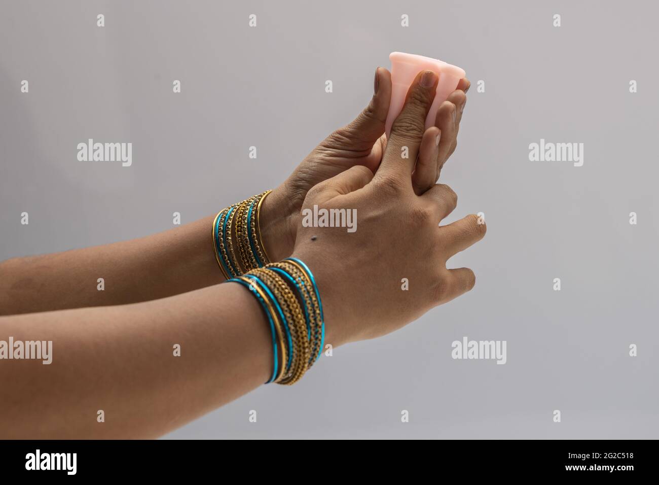 An Indian woman hand holding reusable silicon Menstrualcup and showing ...