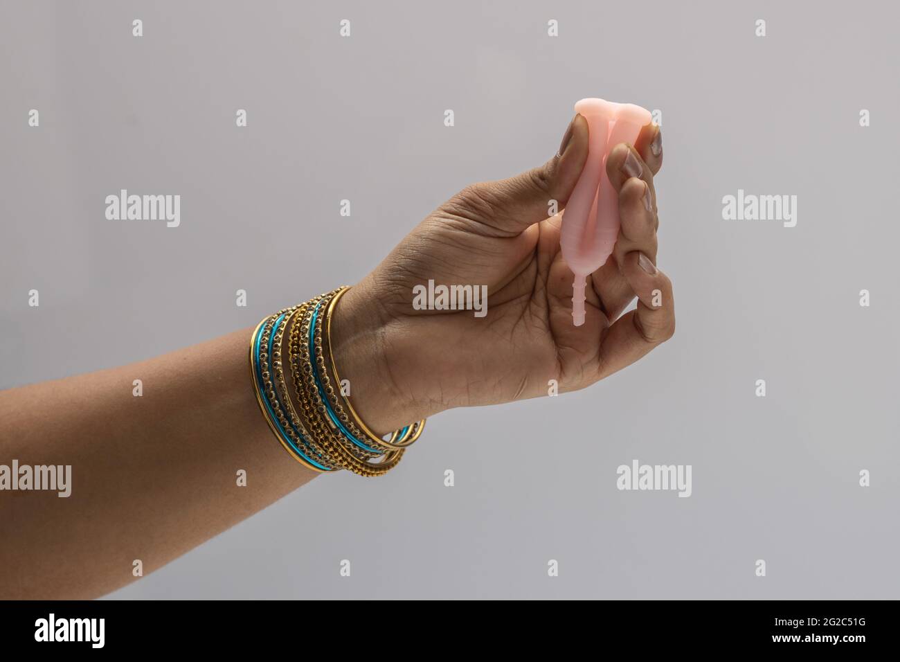 An Indian woman hand holding reusable silicon Menstrualcup and showing ...