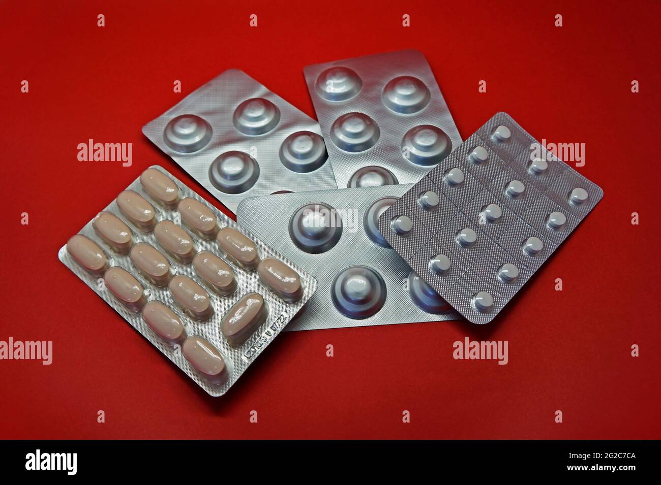 Blister packs of pills on red background Stock Photo - Alamy