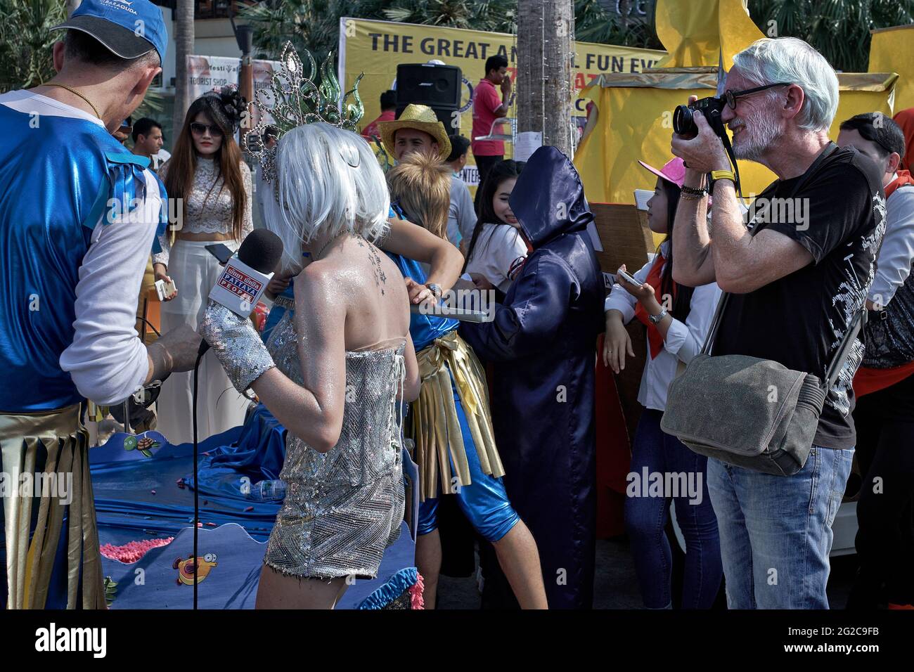 Street photographer taking photographs amongst a crowd of people Stock ...