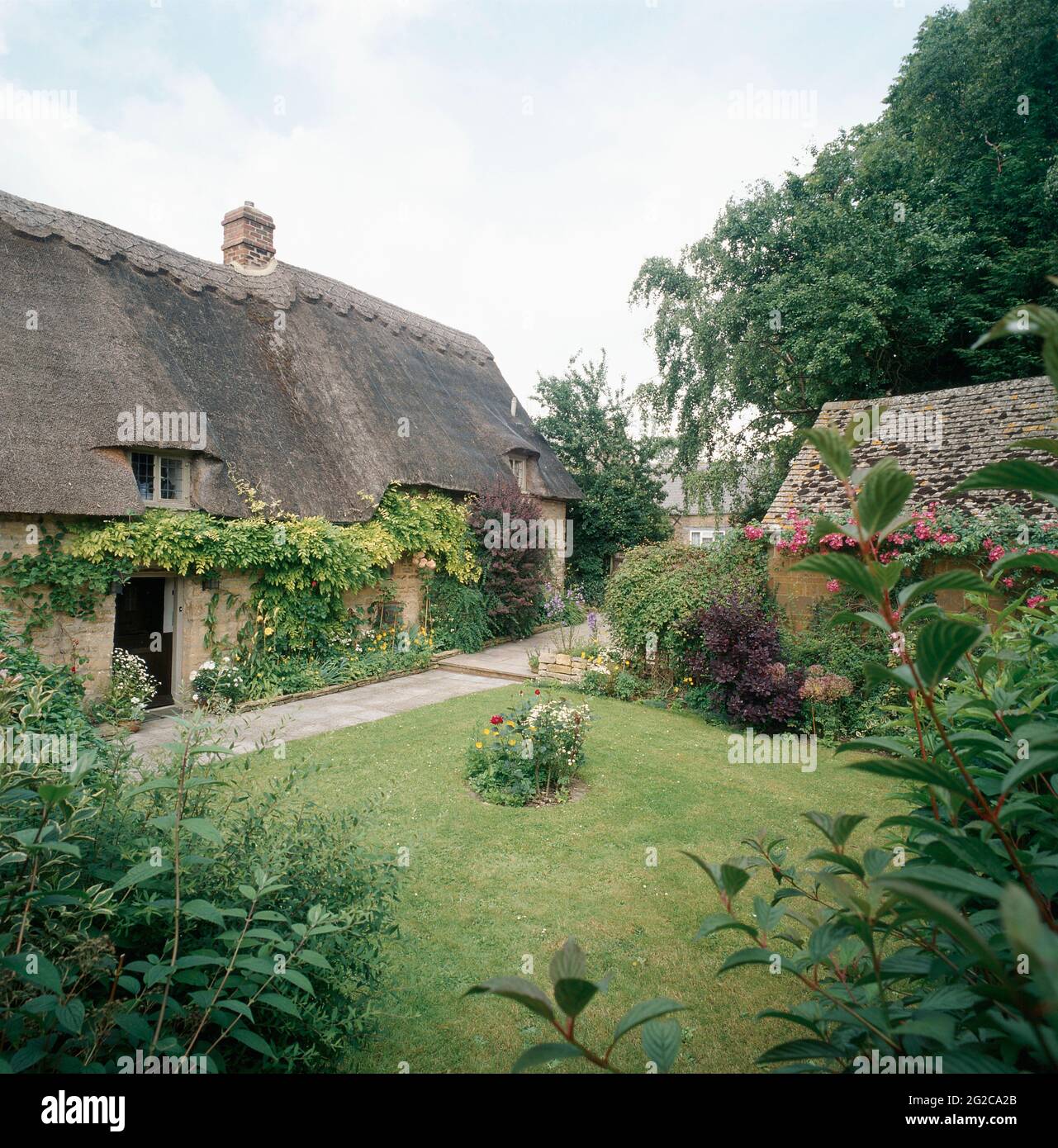 Front yard facade rustic house thatched roof hi-res stock photography ...