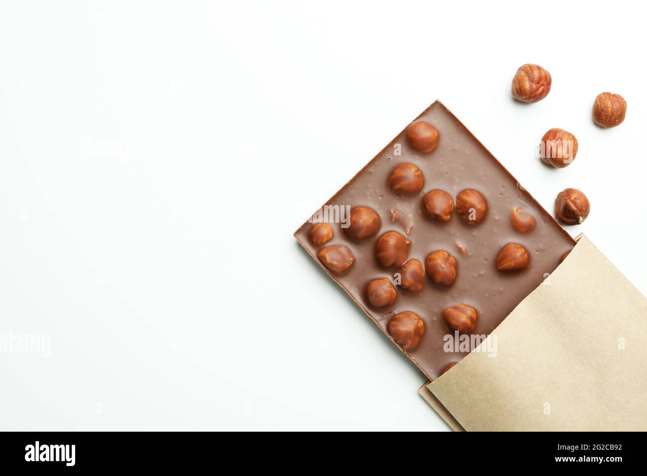 Tasty chocolate bar in paper on white background Stock Photo - Alamy