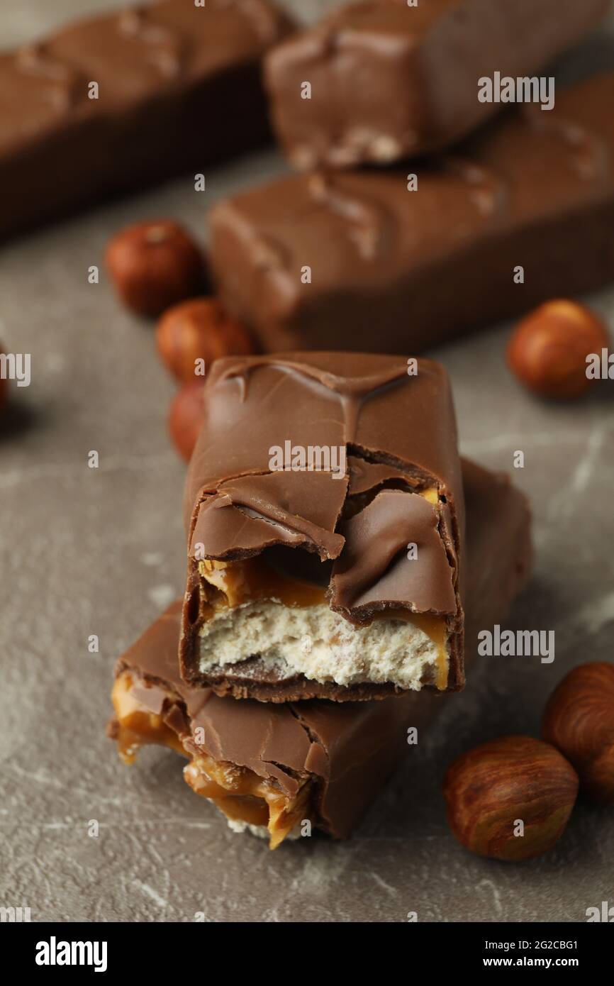 Candy bars and nuts on gray textured table Stock Photo - Alamy