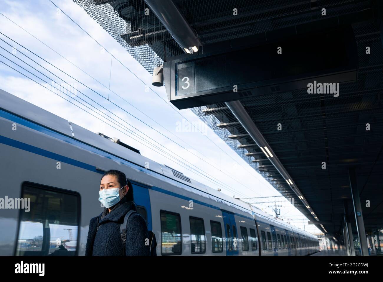 Woman on train station platform Stock Photo - Alamy
