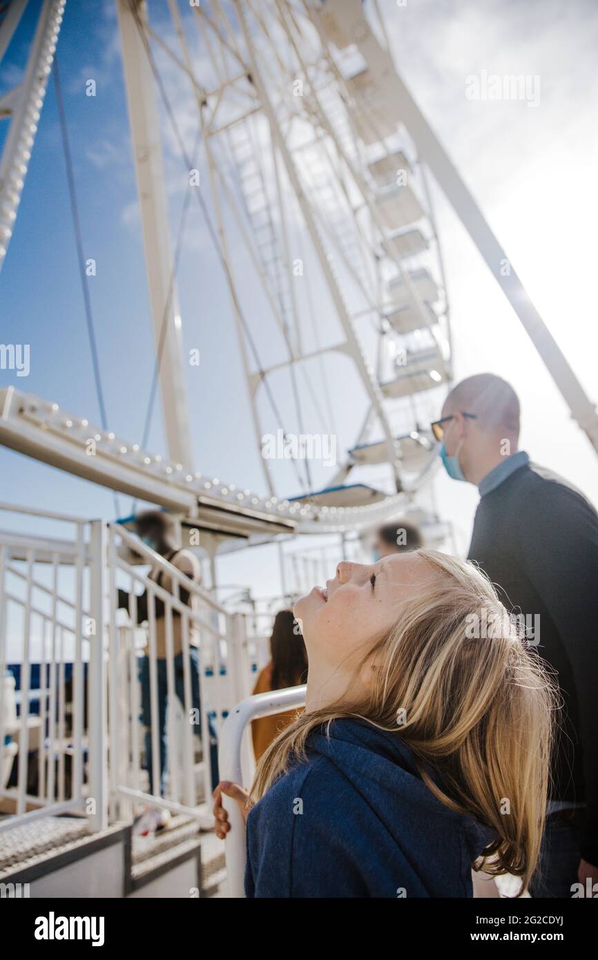 Boy looking at ferris wheel hi-res stock photography and images - Alamy