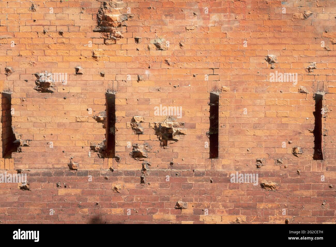 A loophole in an old stone wall. The fortification stone wall of an ...