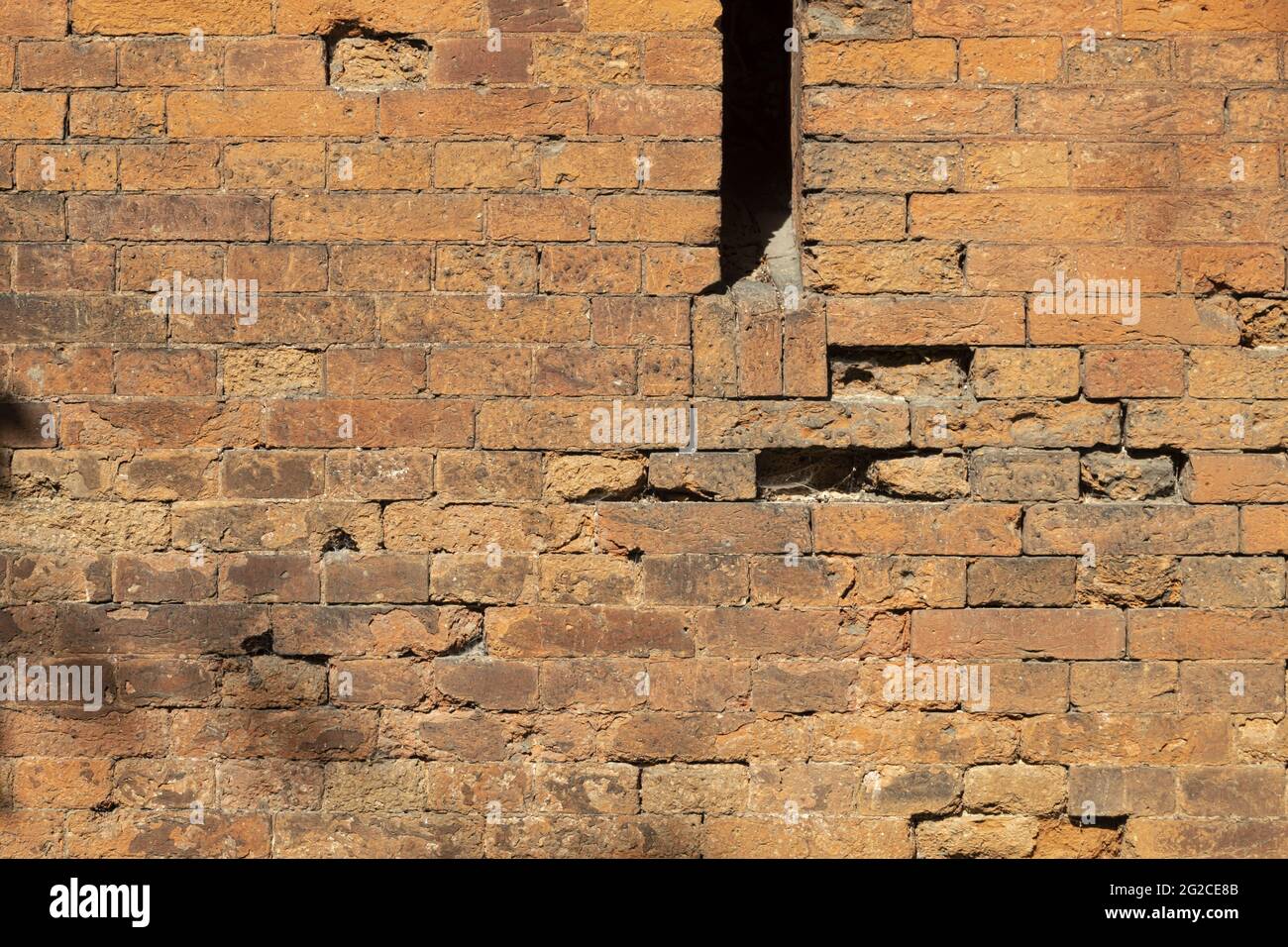 A loophole in an old stone wall. The fortification stone wall of an ...