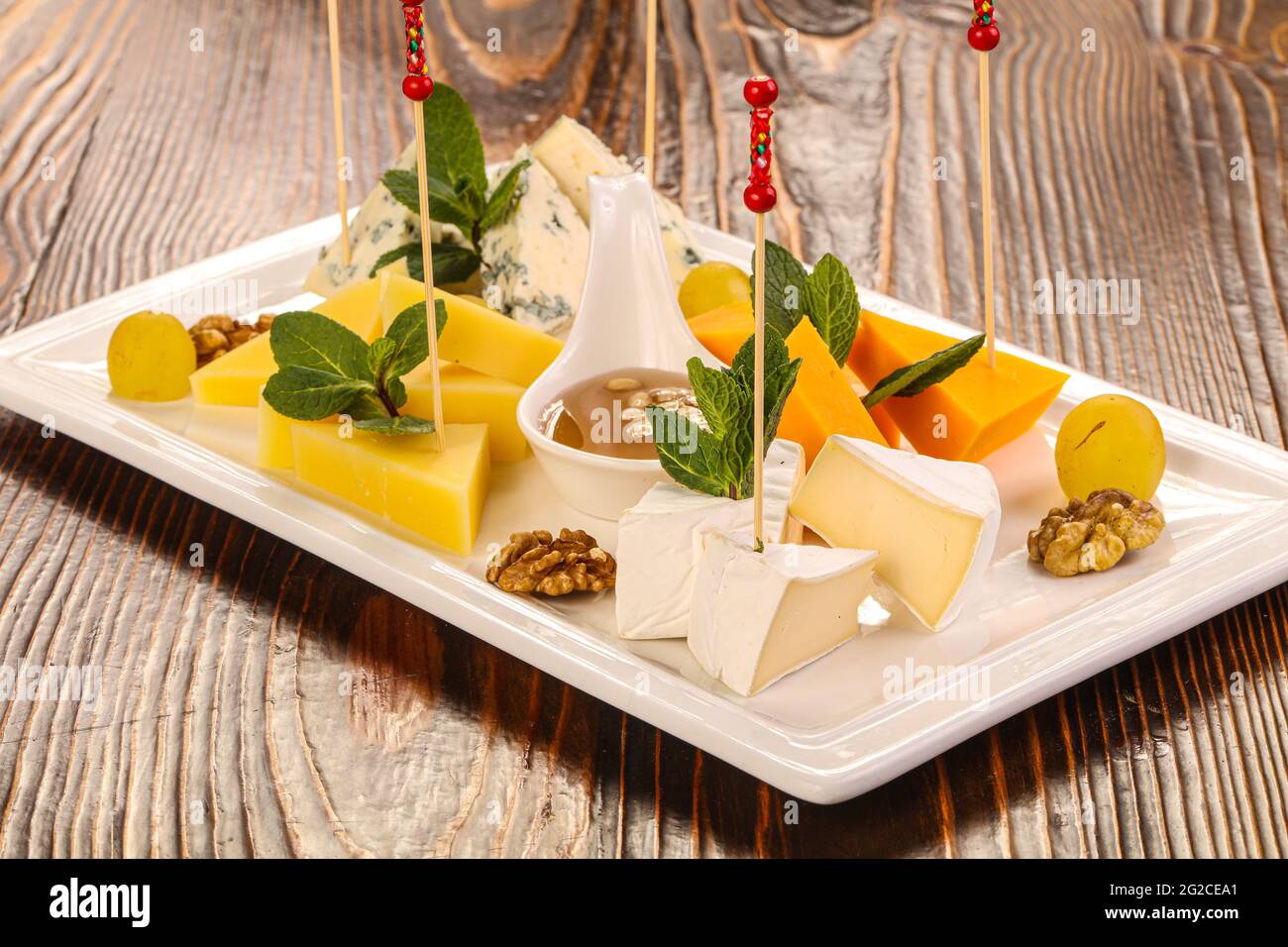 Cheese plate mix with honey and nuts Stock Photo - Alamy