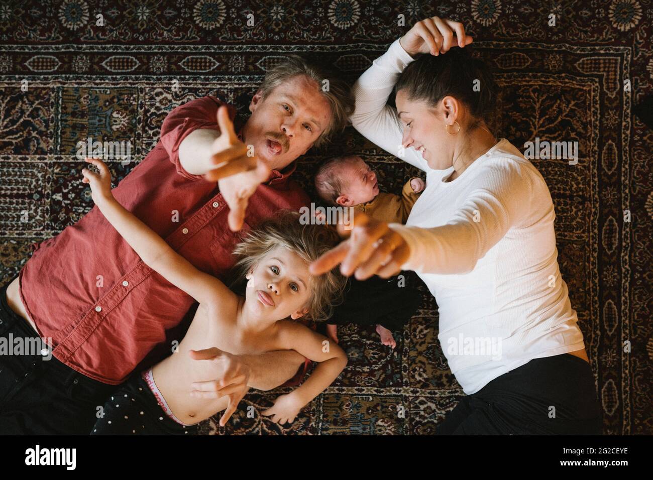 Parents with two children looking at camera Stock Photo - Alamy