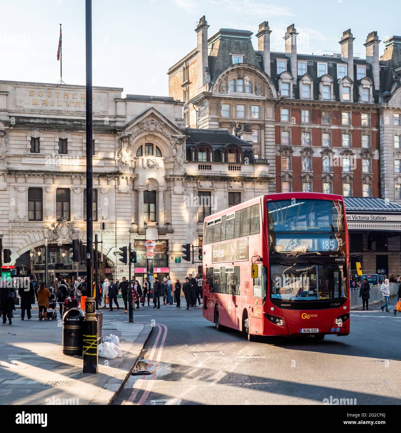 Victoria Railway Station, London. A modern red double decker bus ...
