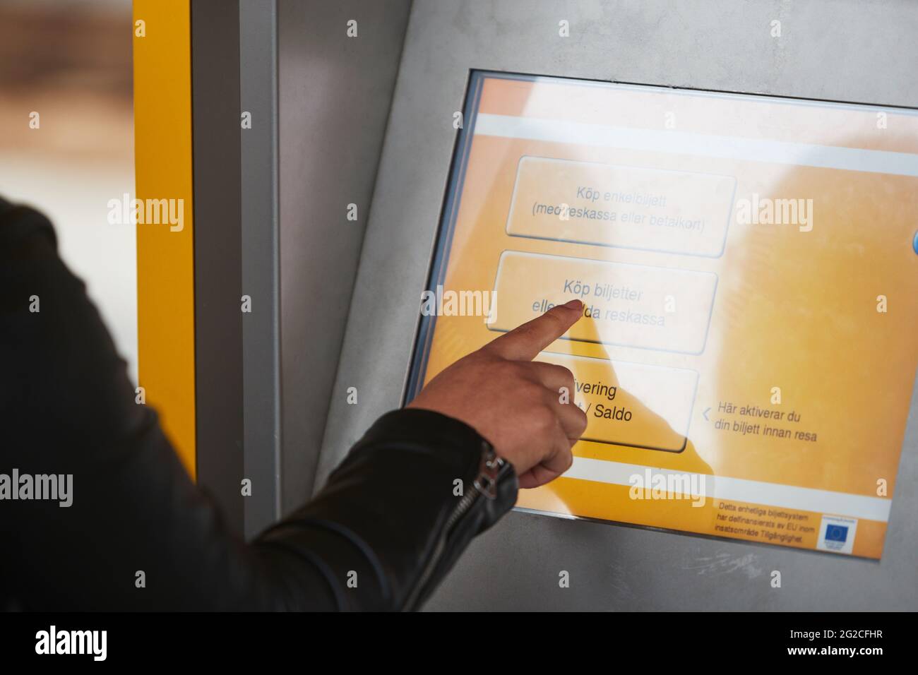 Hand using ticket machine Stock Photo - Alamy