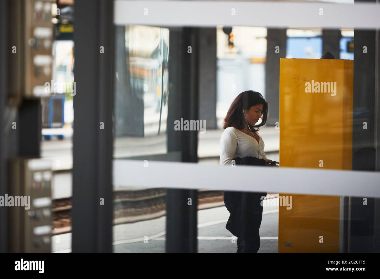 Woman using ticket machine Stock Photo - Alamy
