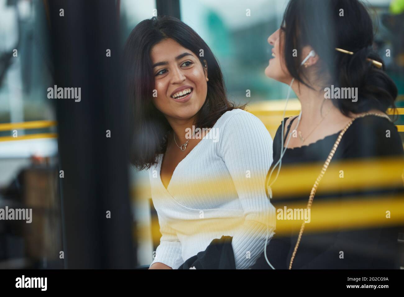 Female friends talking in bus Stock Photo - Alamy