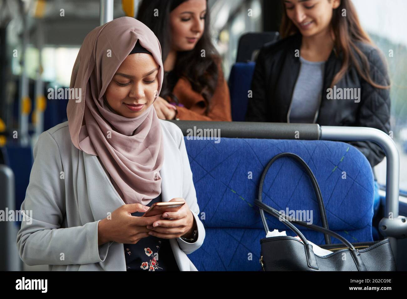 Young woman in bus using cell phone Stock Photo - Alamy