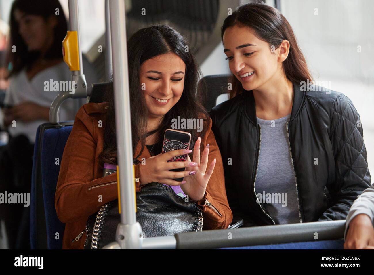 Two young women bus stop hi-res stock photography and images - Alamy