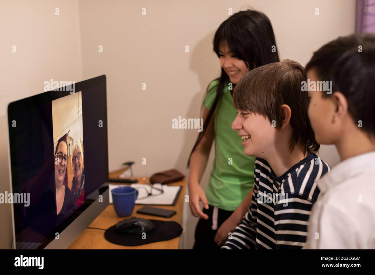 Children talking via video chat with grandmother Stock Photo - Alamy