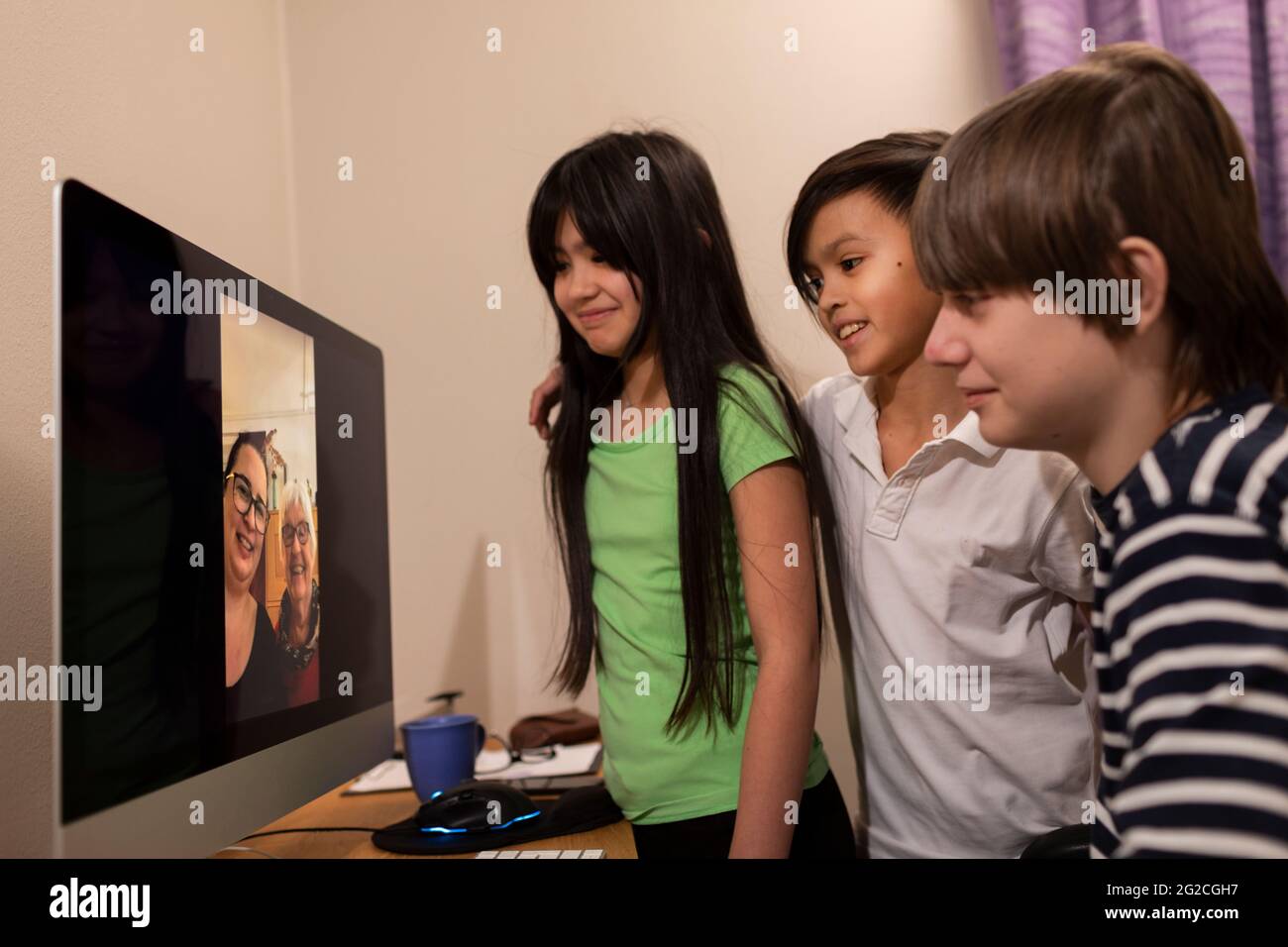 Children talking via video chat with grandmother Stock Photo - Alamy