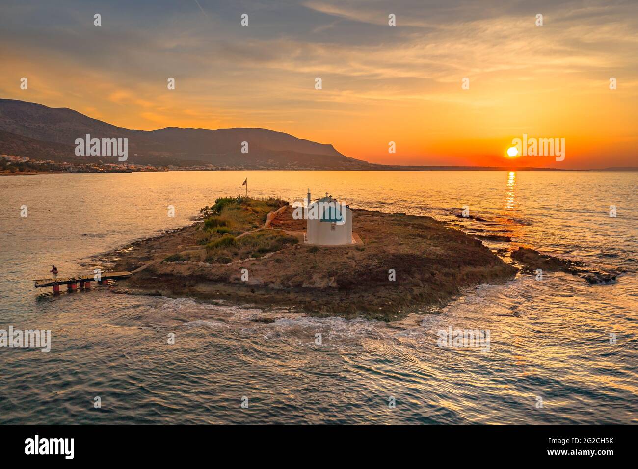 An old white church in a small island at sunset in Malia, Crete, Greece ...