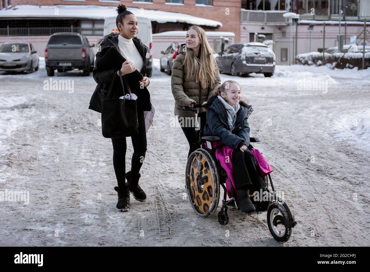 Girl pushing wheelchair hi-res stock photography and images - Alamy